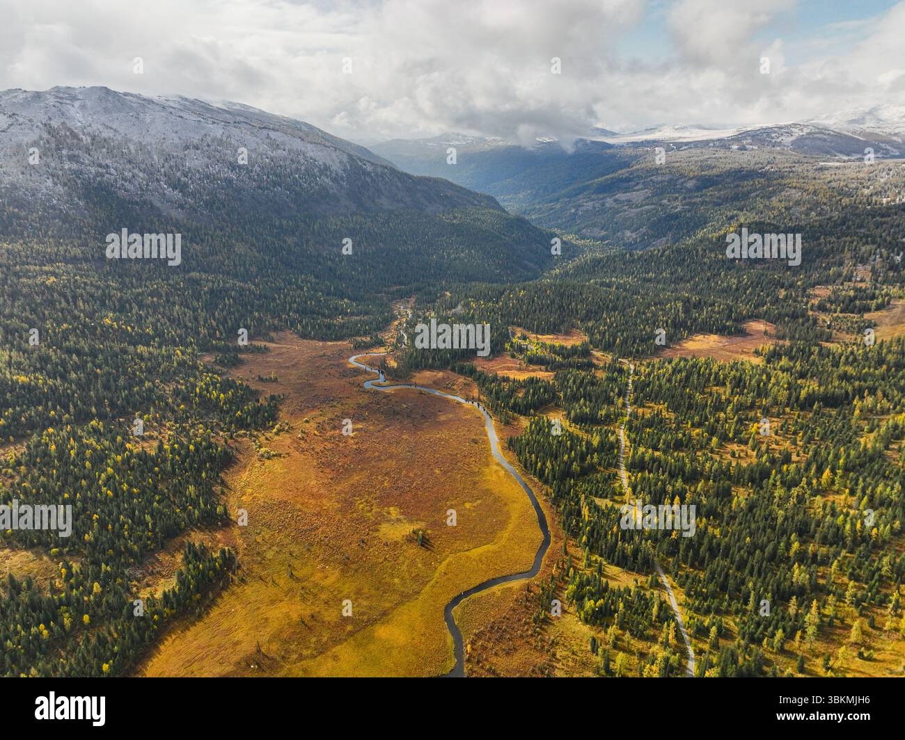 An aerial view showcases a meandering river flowing through an ...