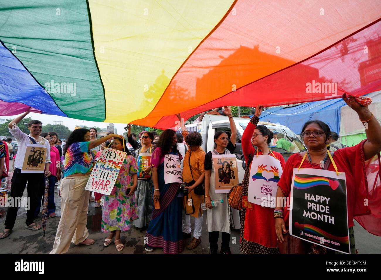 Activists and supporters of LGBTQ community participate in a pride walk ...