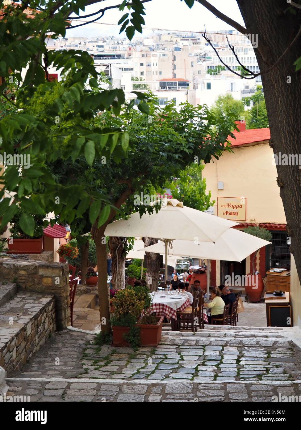 Lively outdoor restaurant under white parasols in Plaka, Athens, Greece ...
