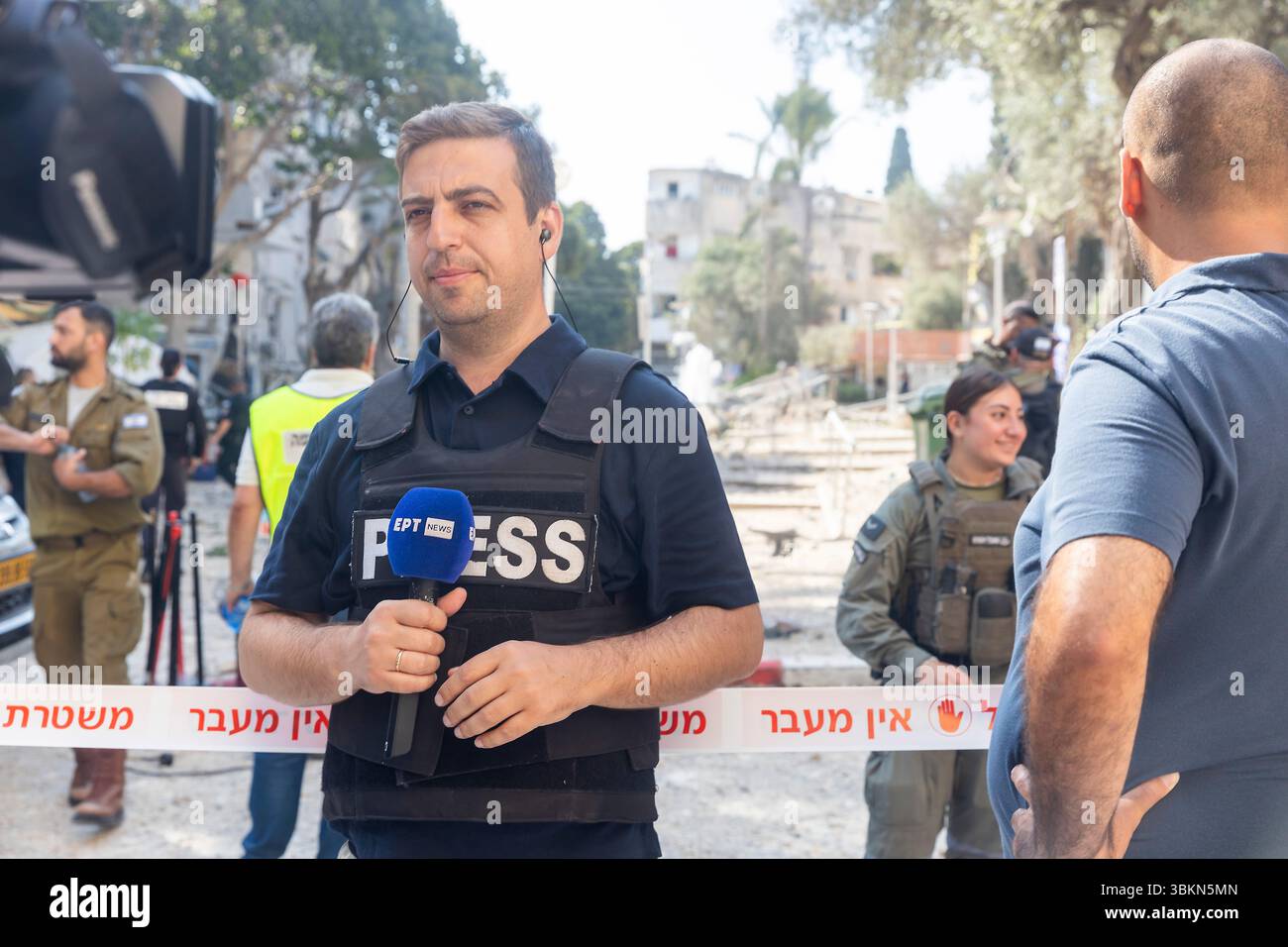 Haifa, Israel, 21 June 2025 A journalist broadcasts from a cordoned-off ...