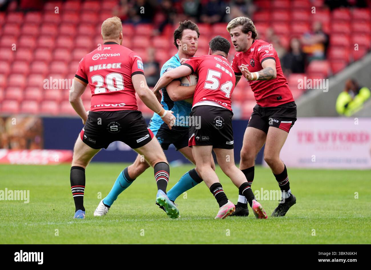 Hull's Yusuf Aydin is tackled by Salford's Cain Robb during the Betfred ...