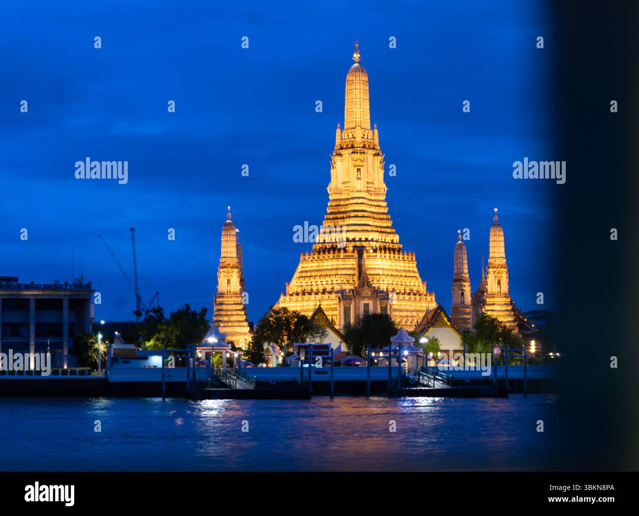 Wat Arun temple at night from across the Chao Phraya river Stock Photo ...