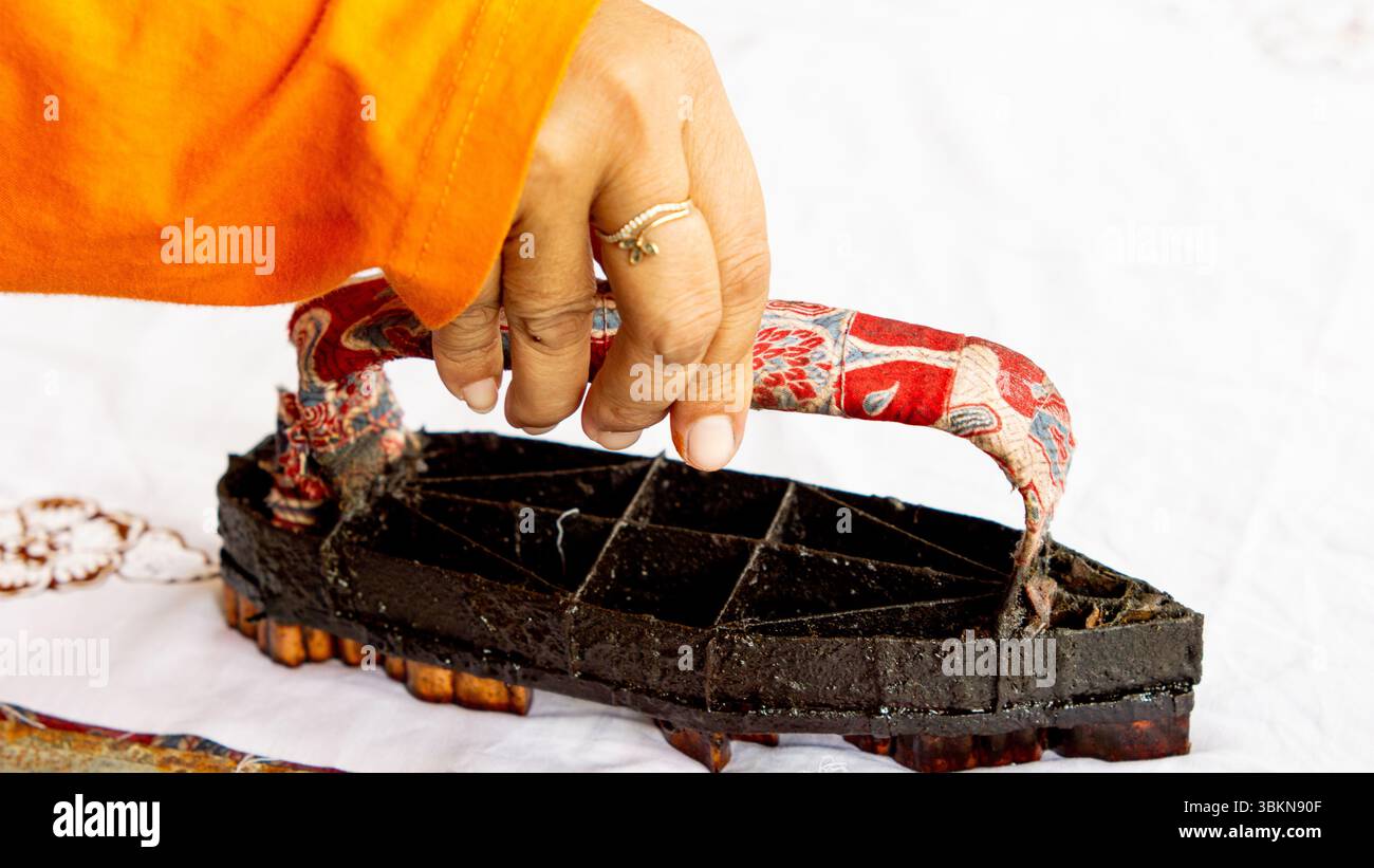 The process of making batik cloth. Batik is a type of cloth whose ...