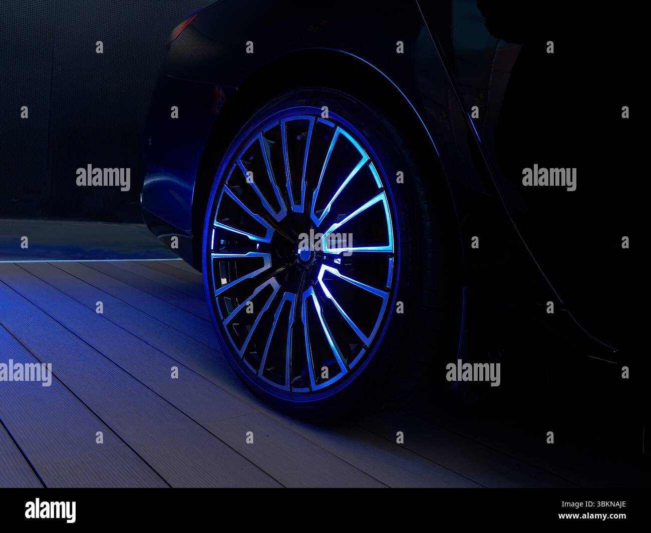 Illuminated Car Wheel with Vibrant Neon Blue Light in Modern Setting ...