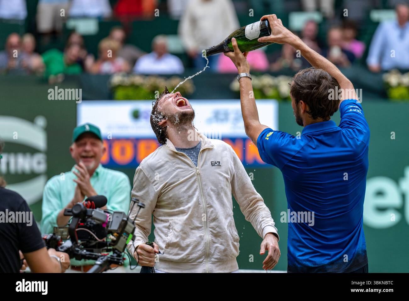 Kazakhstan's Alexander Bublik, left, is sprayed with sparkling wine by ...