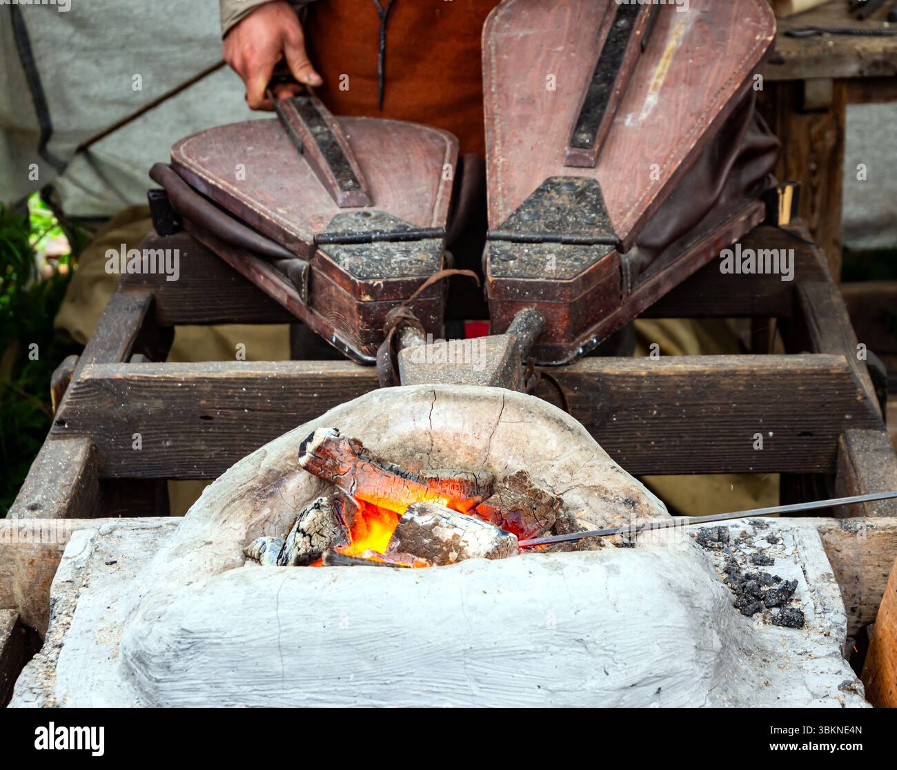 The process of blowing a forge furnace with hand bellows Stock Photo - Alamy