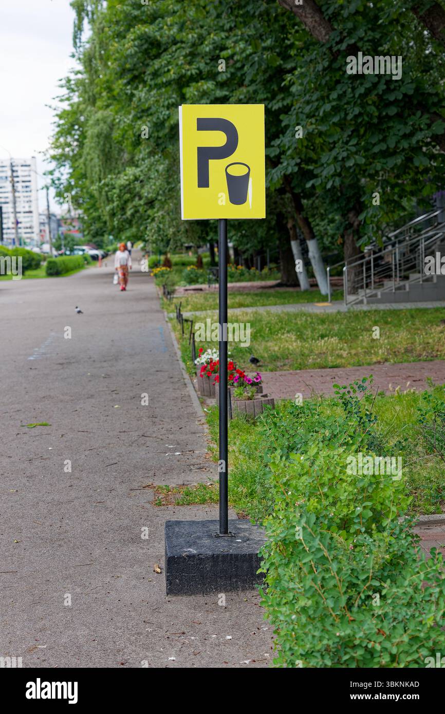 A rectangular road sign with a yellow background indicating parking for ...