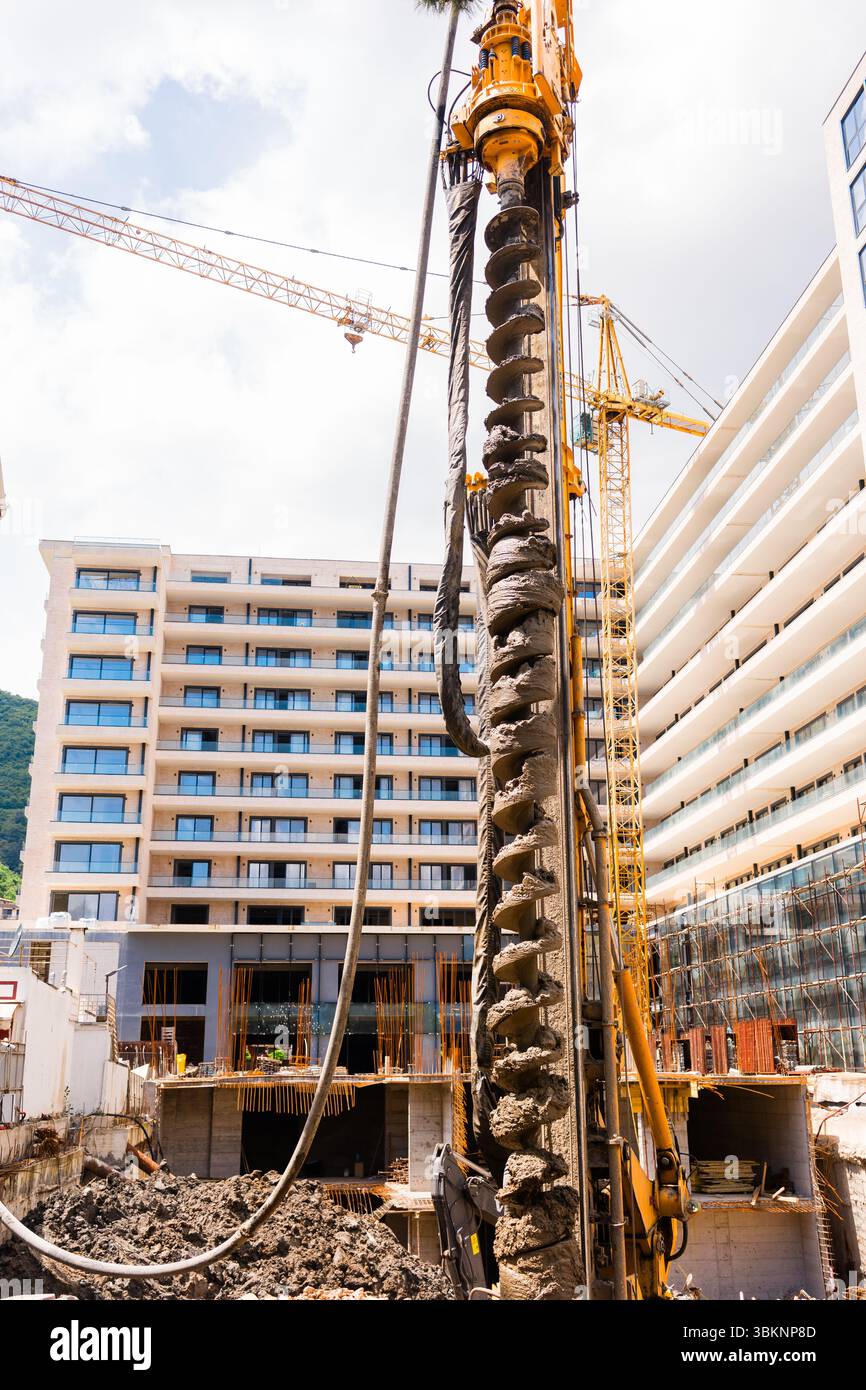 Drilling rig operating at urban construction site. Foundation ...