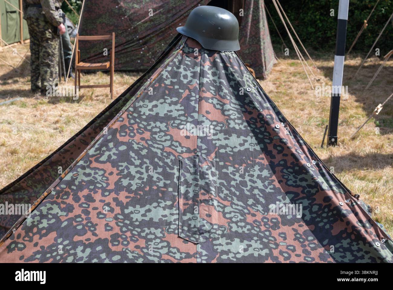 Zeltbahn made into a tent along with a helmet places on top at the ...