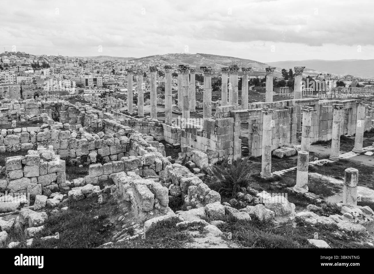 A black and white photo of a city with a lot of old buildings. The ...