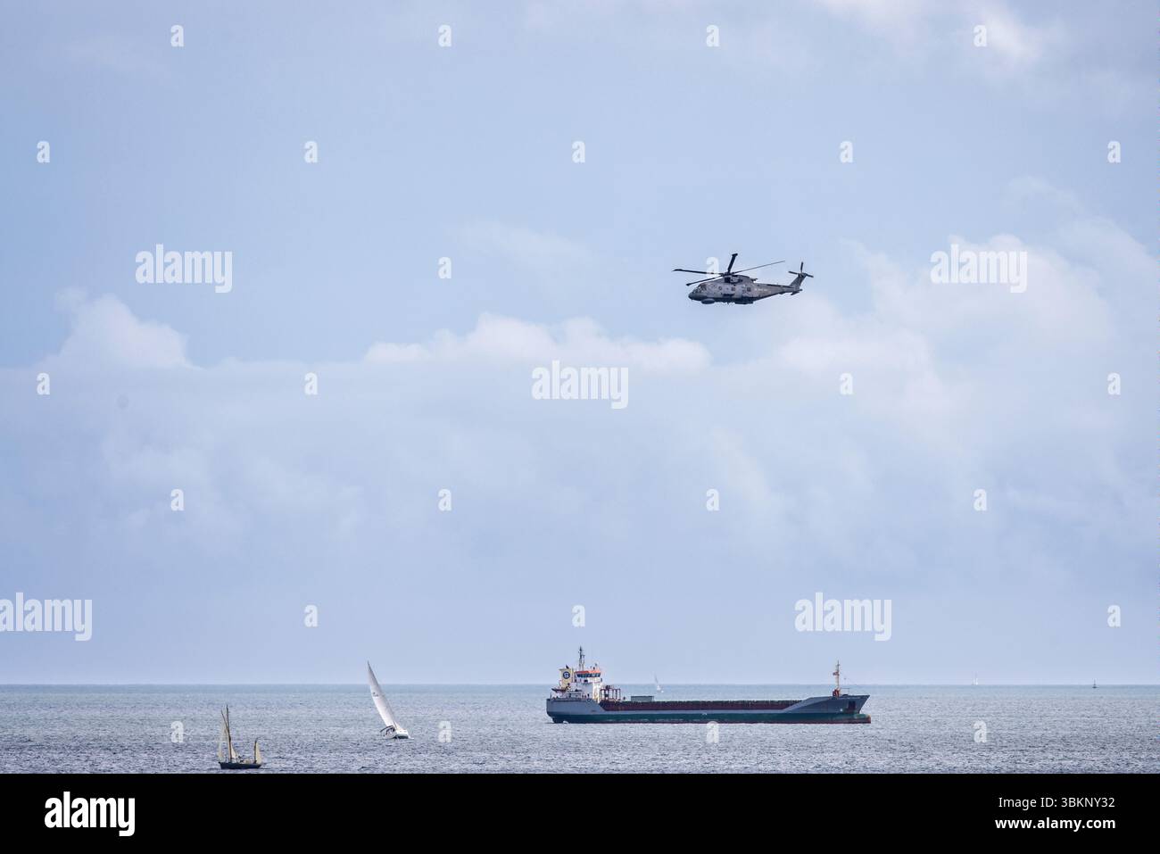 Royal Navy helicopter hovering over tanker and yachts in Falmouth Bay ...