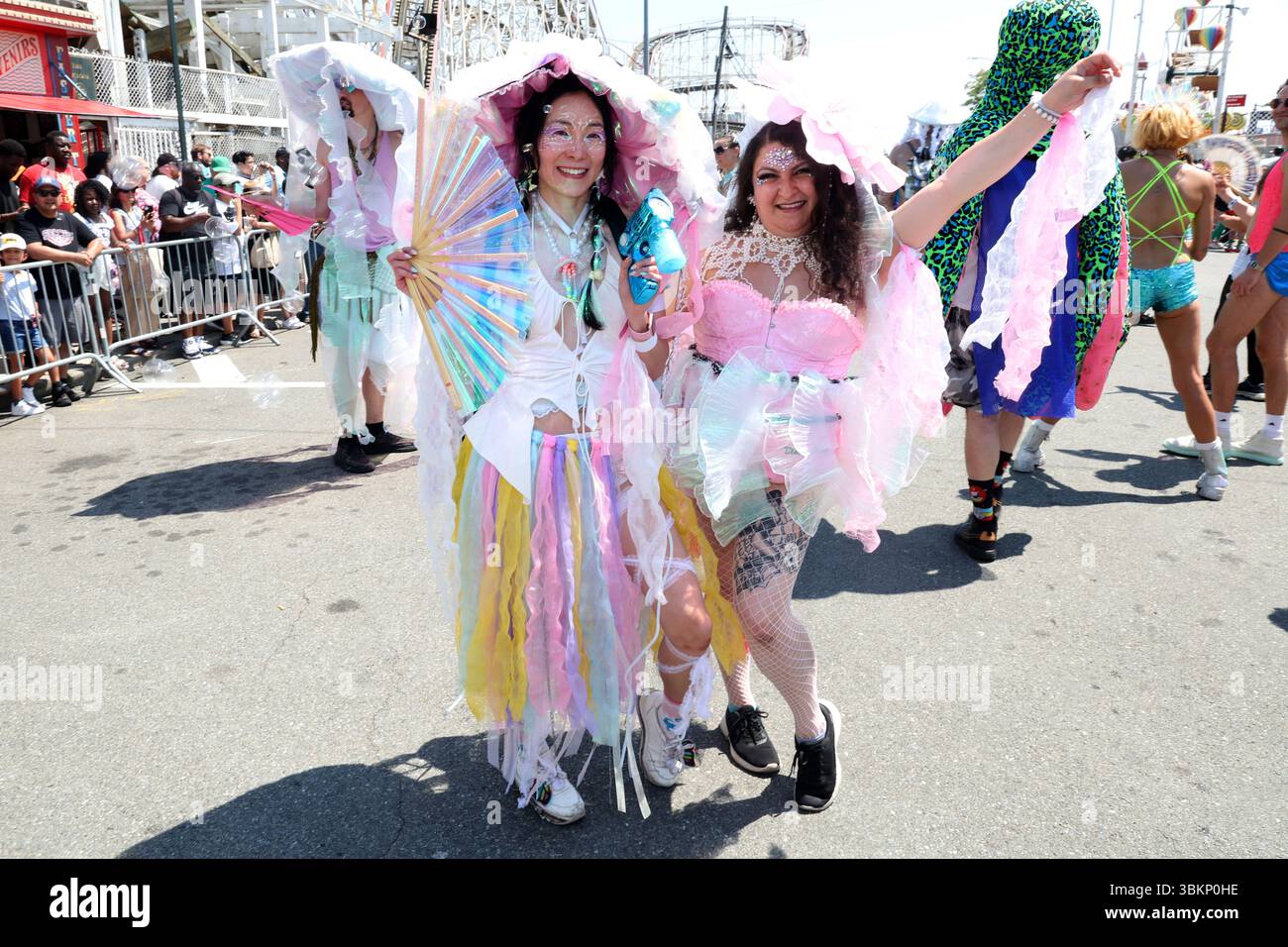 Women dressed as mermaids pose for photos during the Mermaid Parade on ...