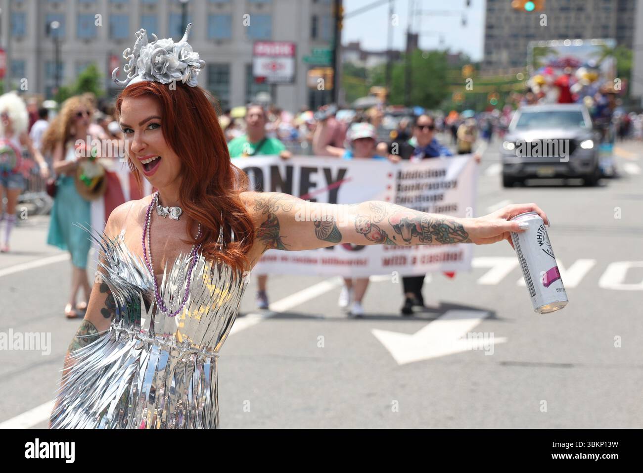 Women dressed as mermaids wave to crowds during the Mermaid Parade on ...
