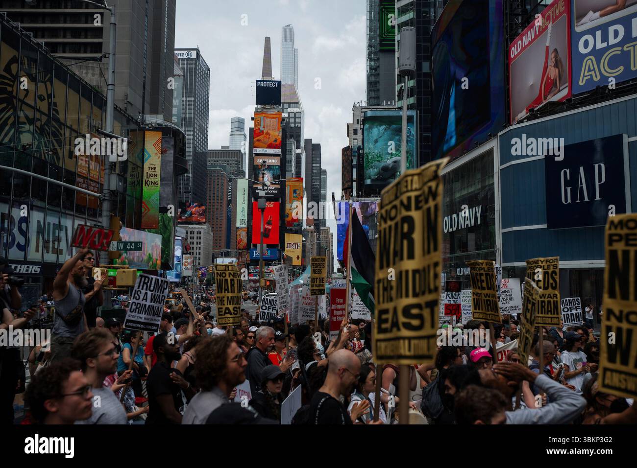 Protesters carry signs during a protest against U.S. strikes on Iran ...