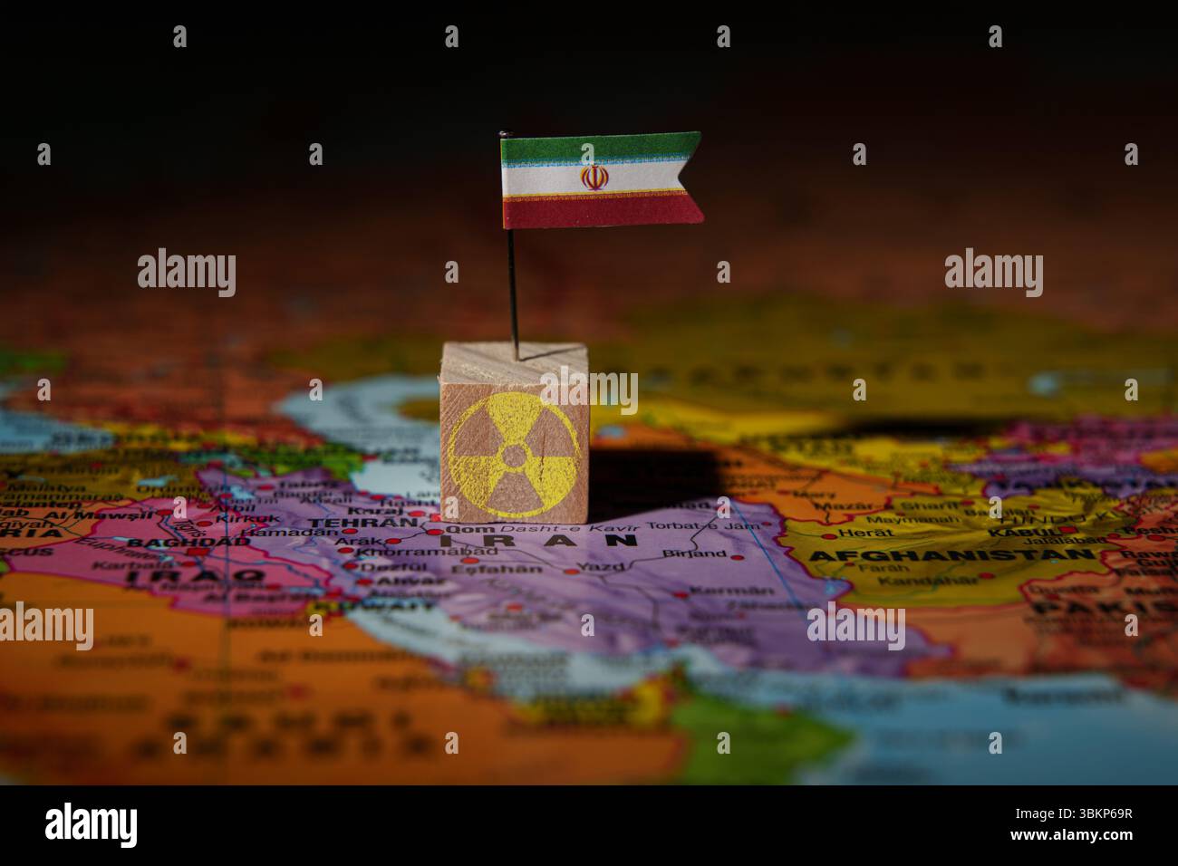 Iran flag pin on map with nuclear symbol block, representing nuclear ...