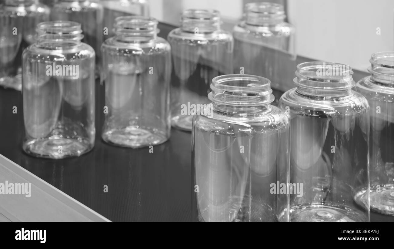 Many bottles on conveyor belt in factory Black and White Stock Photos ...
