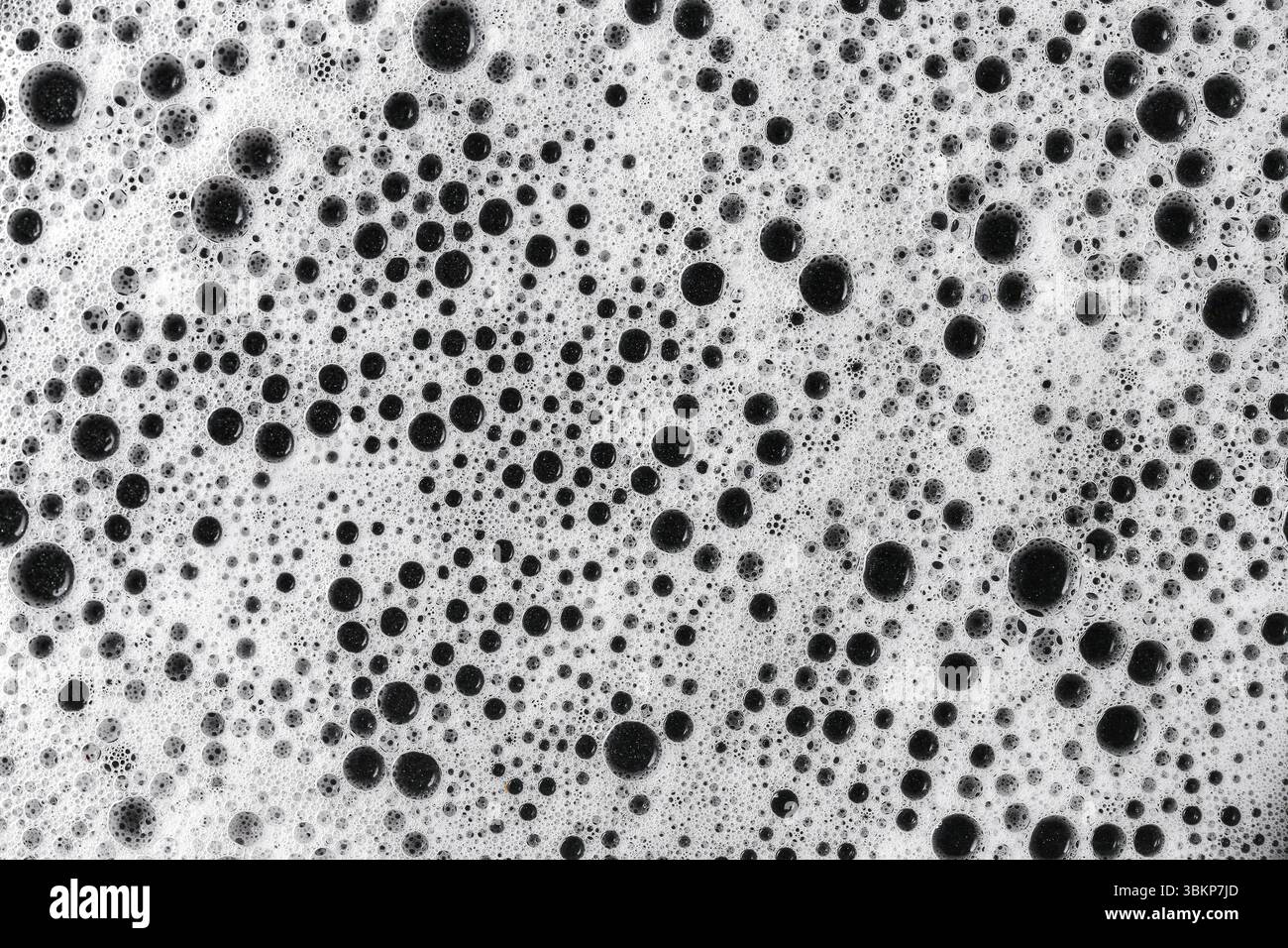Dense foam with black bubbles texture. Cleaning detergent surface close ...