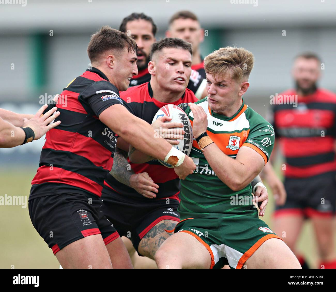 Leeds, UK. 22nd June, 2025. Josh Ward of Hunslet is tackled by Tom ...