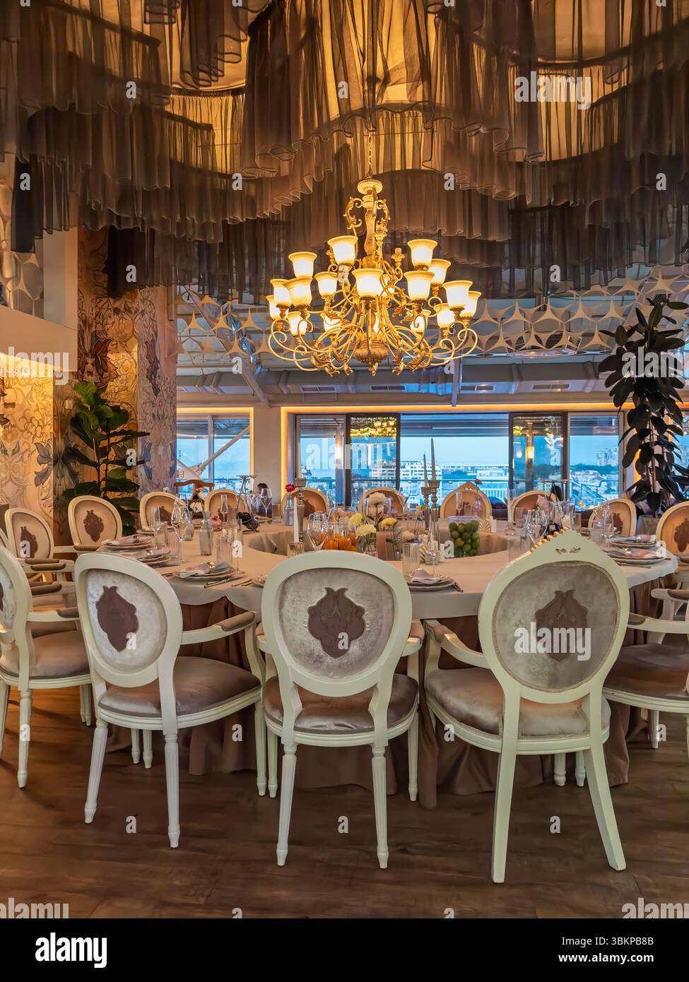 Elegant banquet hall with a beautifully set round table for a wedding ...
