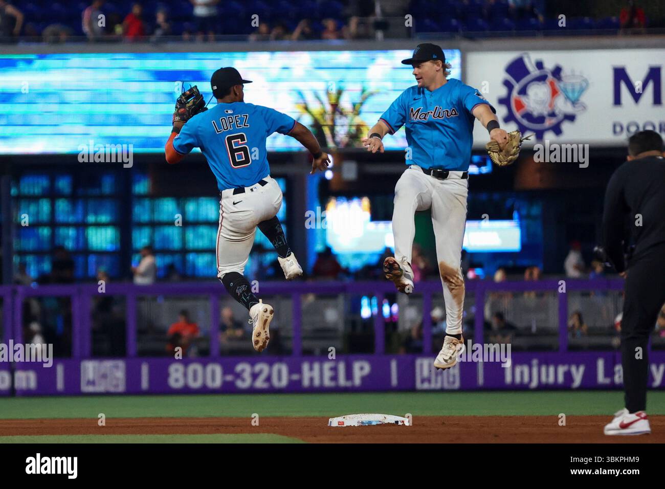 Miami Marlins' Otto Lopez (6) and Kyle Stowers celebrate after a ...