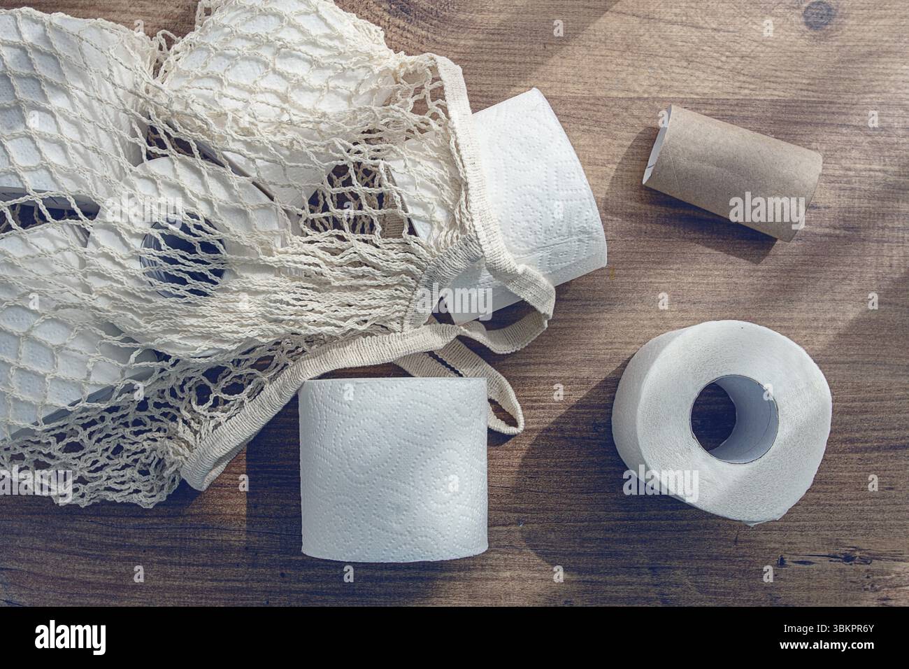 Mesh bag on the table, with rolls of toilet paper, top view, no people ...