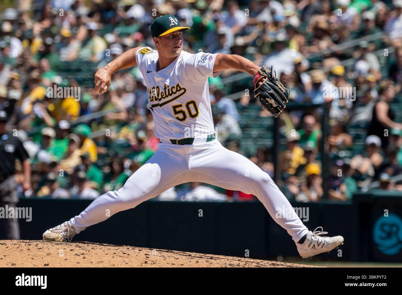 Athletics pitcher Jack Perkins throws to the Cleveland Guardians during ...