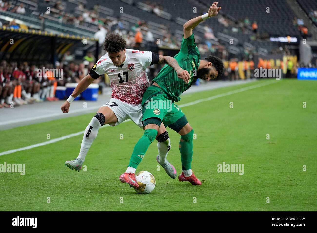 Trinidad and Tobago's Rio Cardines, left, and Saudi Arabia's ...