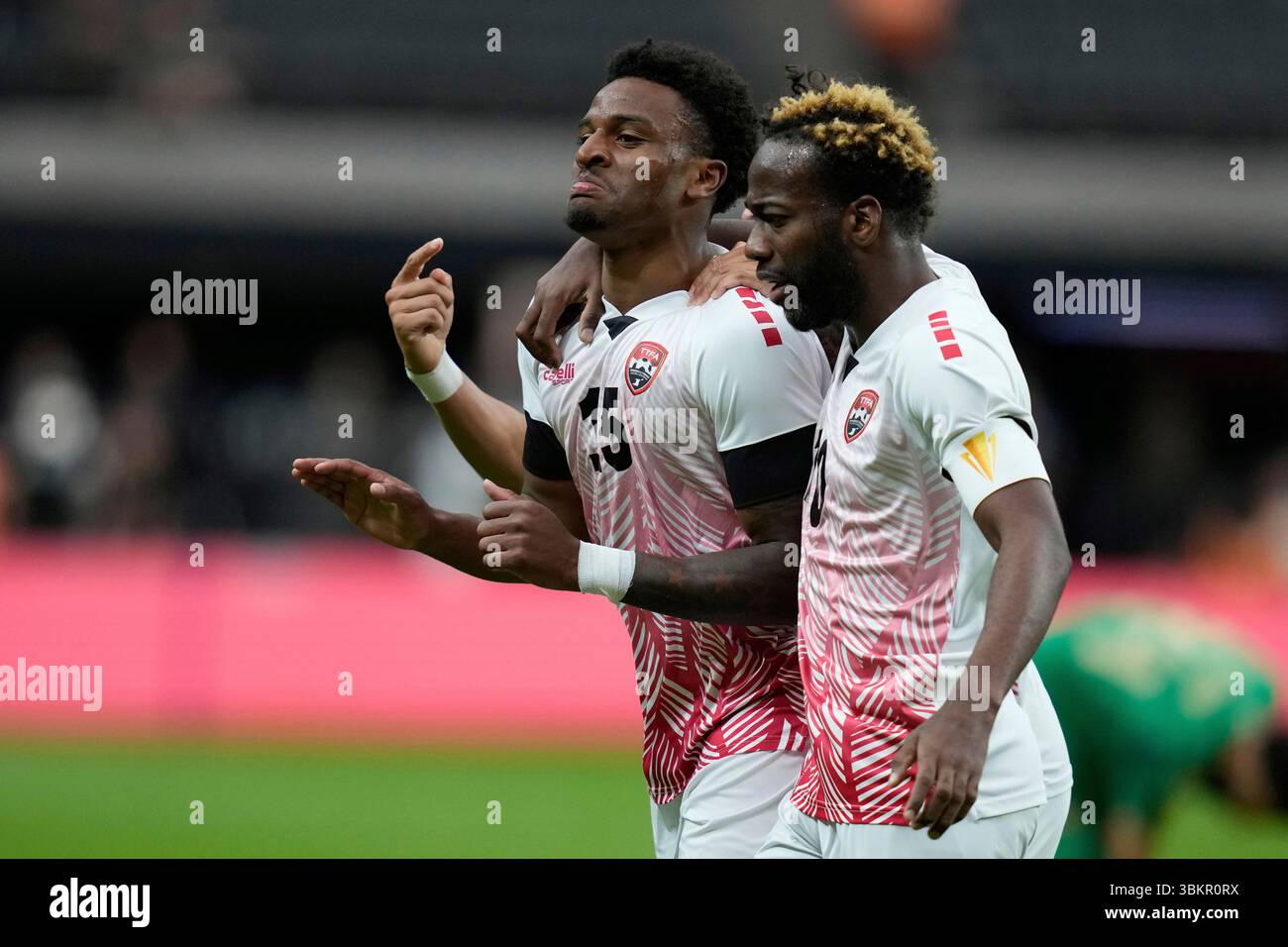 Trinidad and Tobago's Dante Sealy, left, celebrates after scoring ...