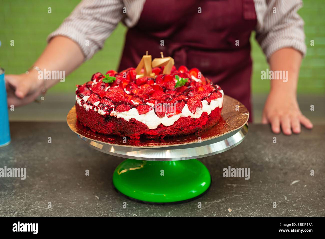 Festive strawberry birthday cake with whipped cream and number candles ...