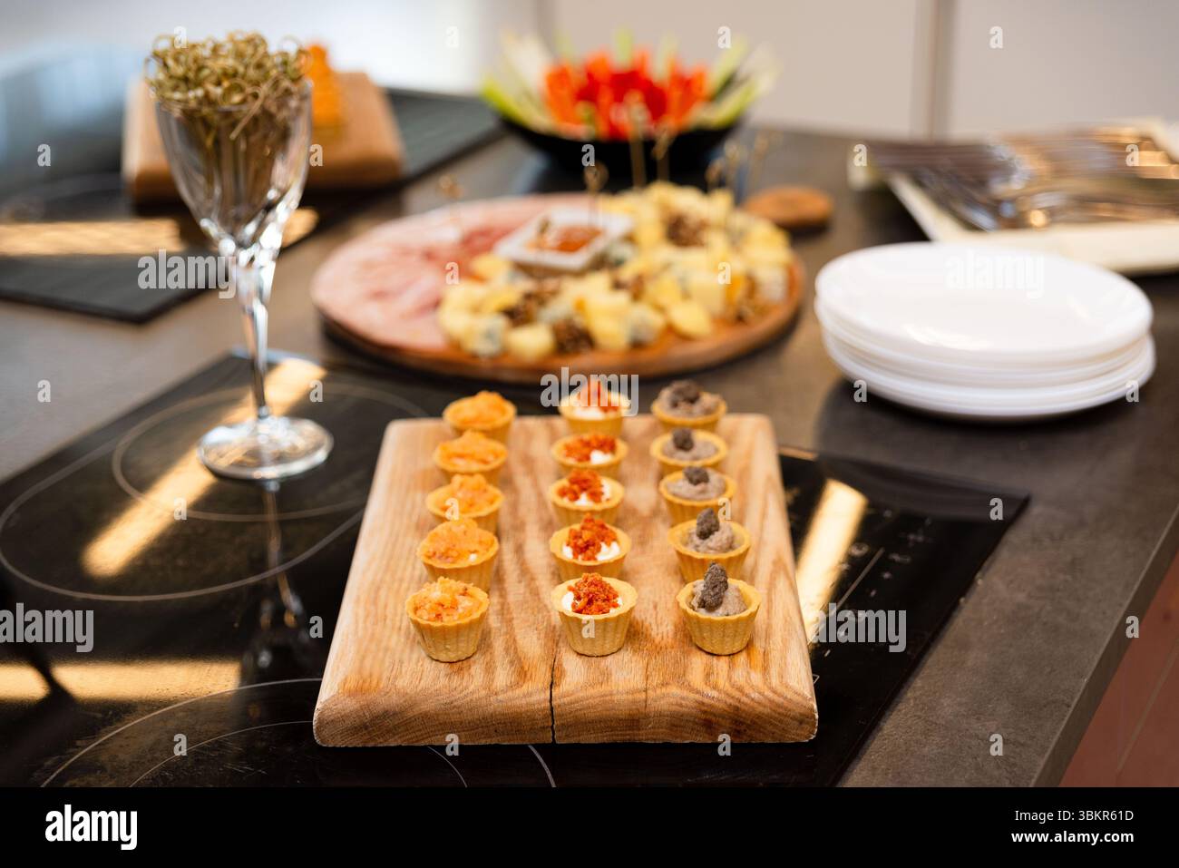 Three types of bite-sized savory tartlets with assorted fillings served ...