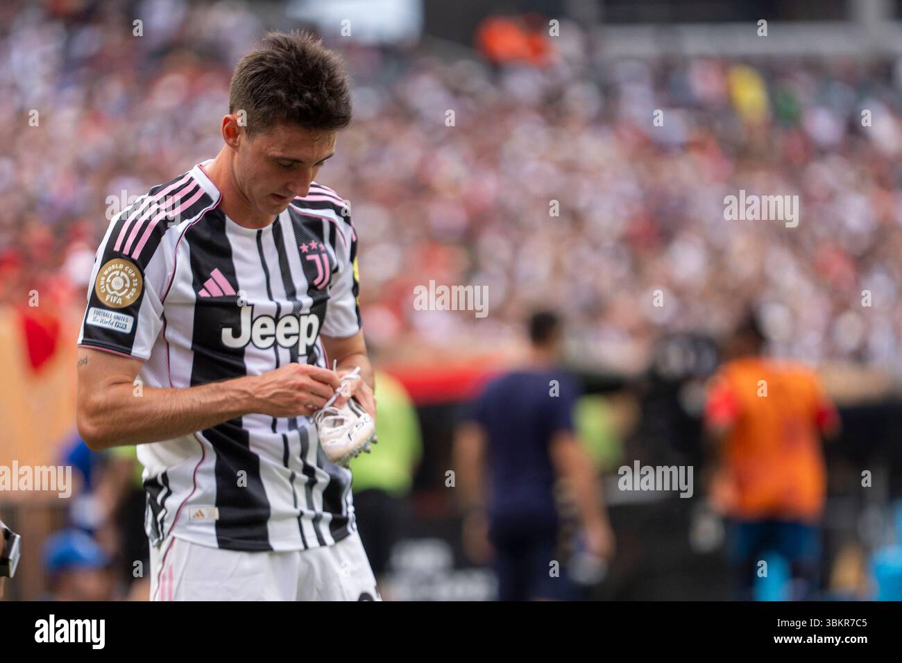 Juventus' Andrea Cambiaso fixes the cleat of Francisco Conceiçao during ...