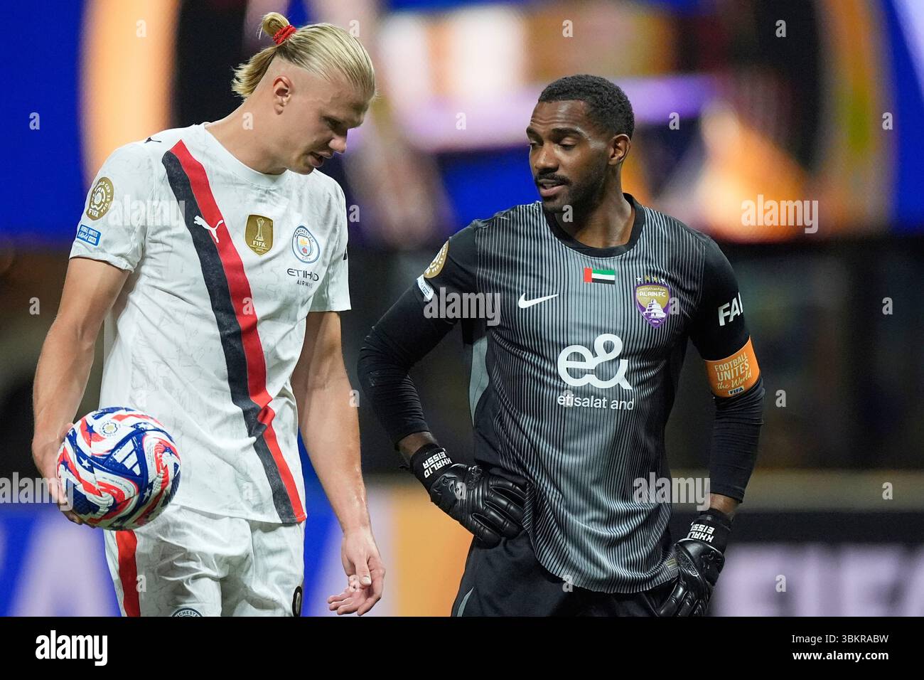 Manchester City's Erling Haaland talks with Al Ain's goalkeeper Khalid ...