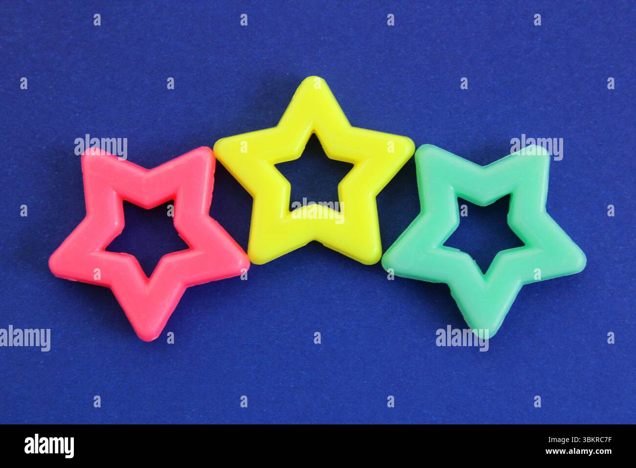 Three colorful stars forming a team Stock Photo - Alamy