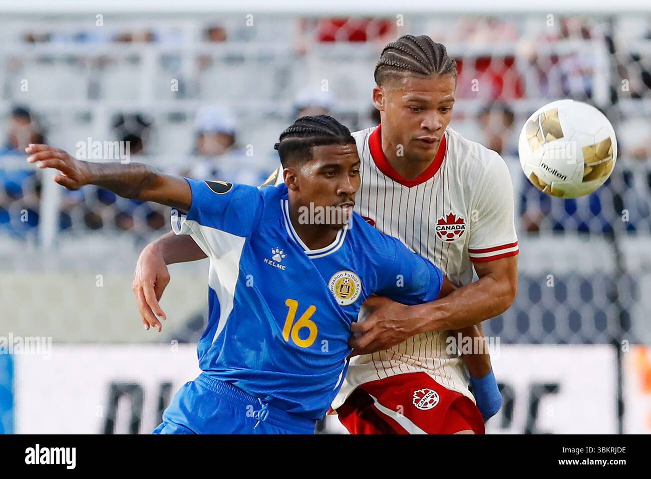 Curacao's Jearl Margaritha (16) chases the ball as he is held by Canada ...