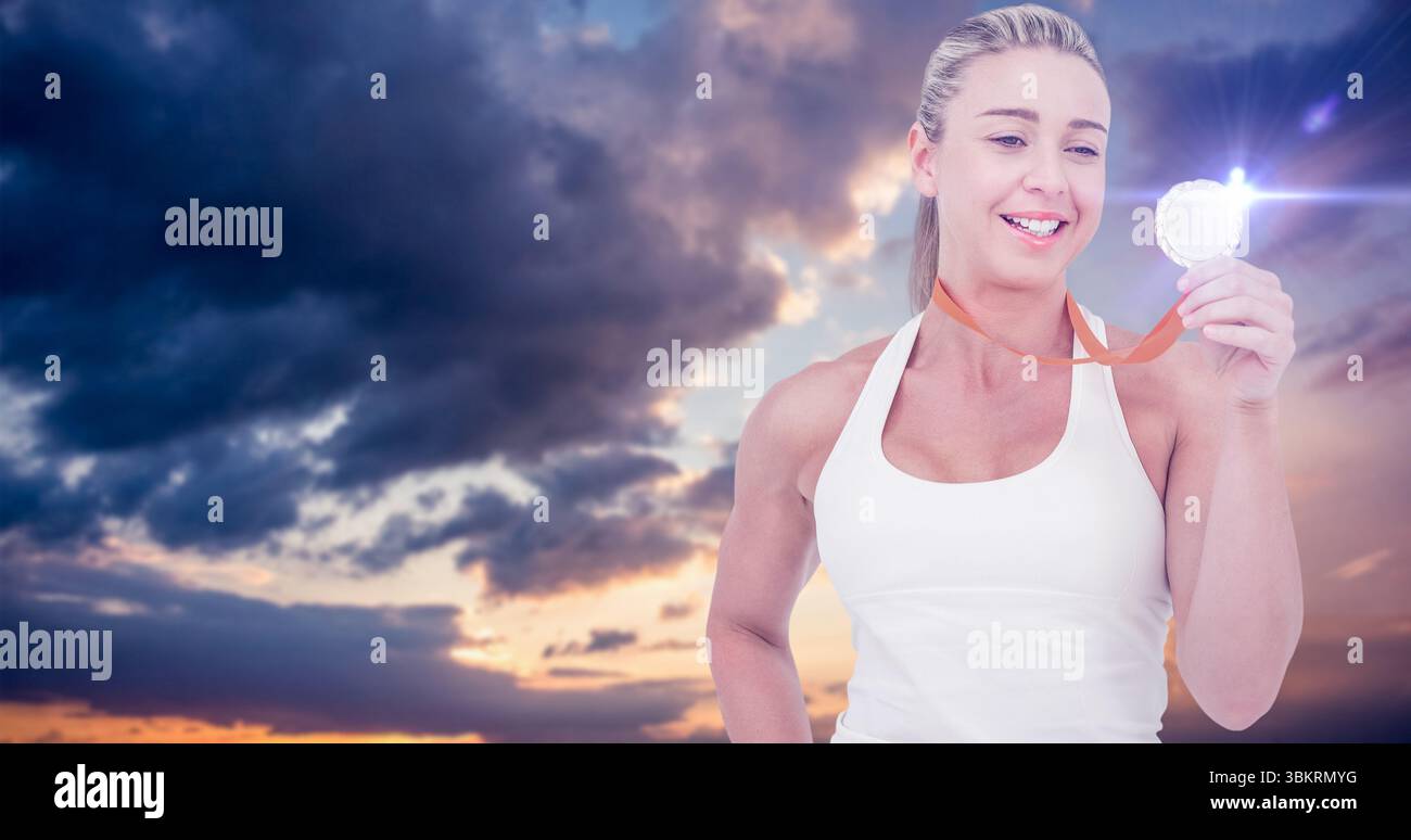 Happy athlete holding gold medal Stock Photo - Alamy