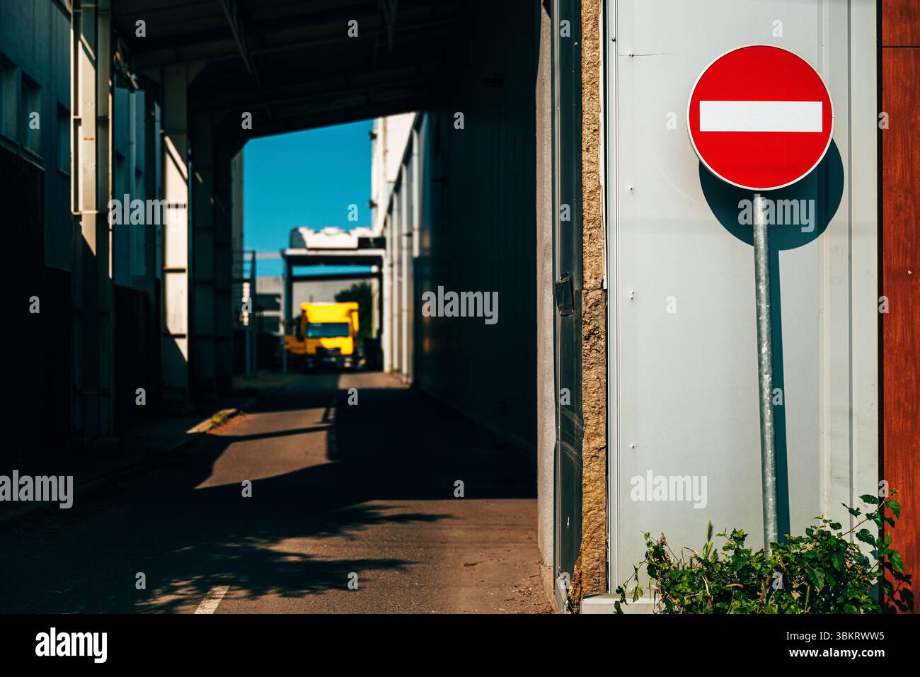 No entry sign at factory warehouse with truck in back, selective focus ...