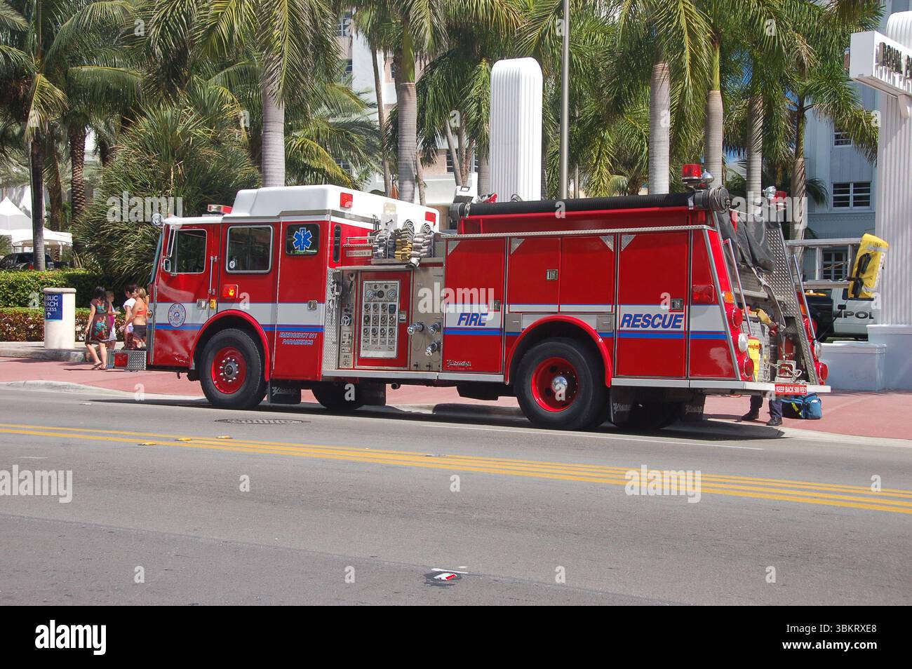 Fire trucks parked along a palm-lined street in front of iconic Art ...