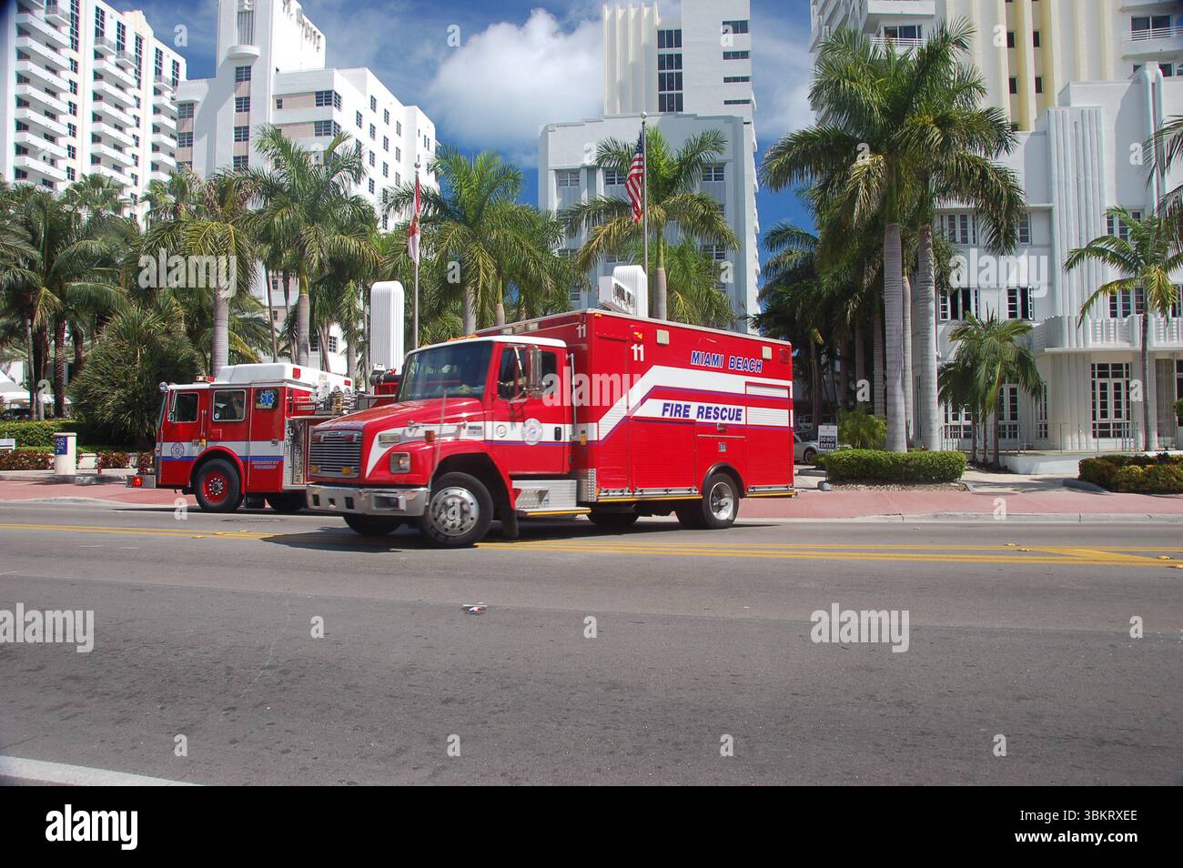 Fire trucks parked along a palm-lined street in front of iconic Art ...
