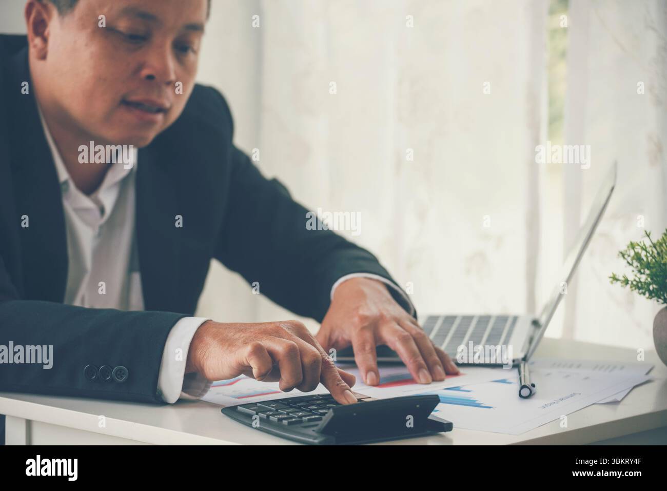 Asian businessman hands calculating number, graph, chart audit planning ...