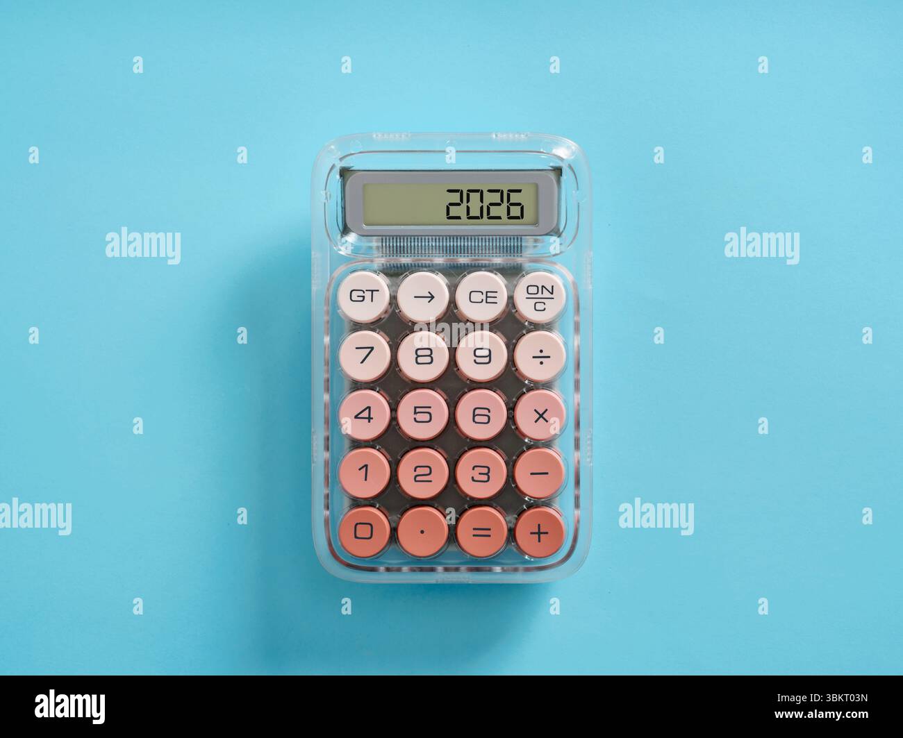 Pink and white calculator showing the year 2026 on its display, placed ...