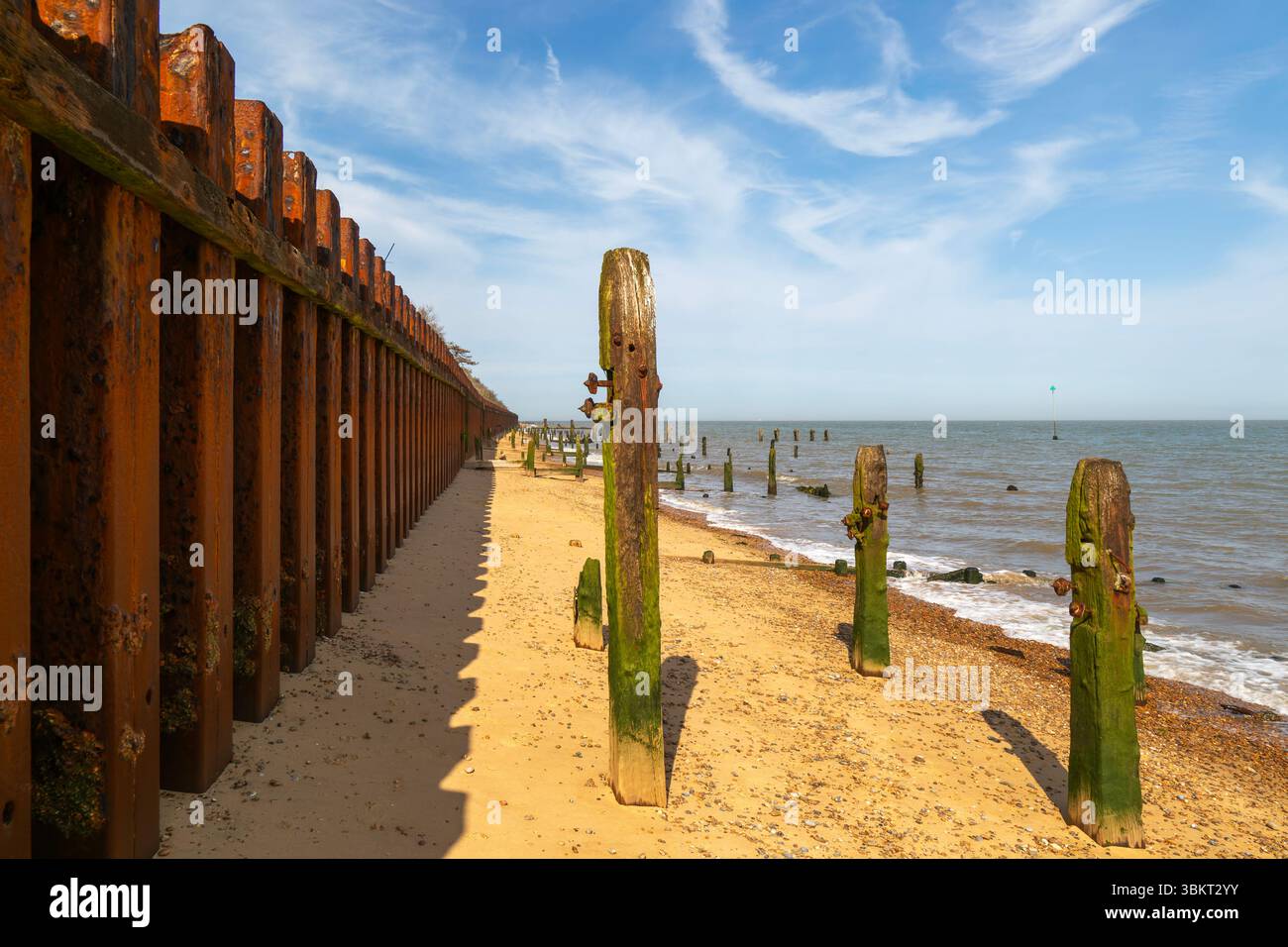 Steel sheet piling sea wall old broken wooden groynes coastal defences ...