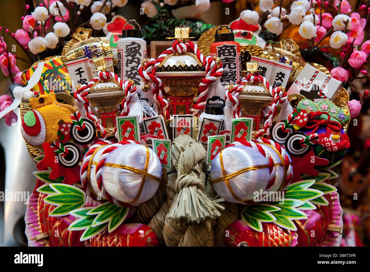 Tori-no-Ichi November event at Otori Jinja Shinto shrine. Believers purchase elaborate New Year ...