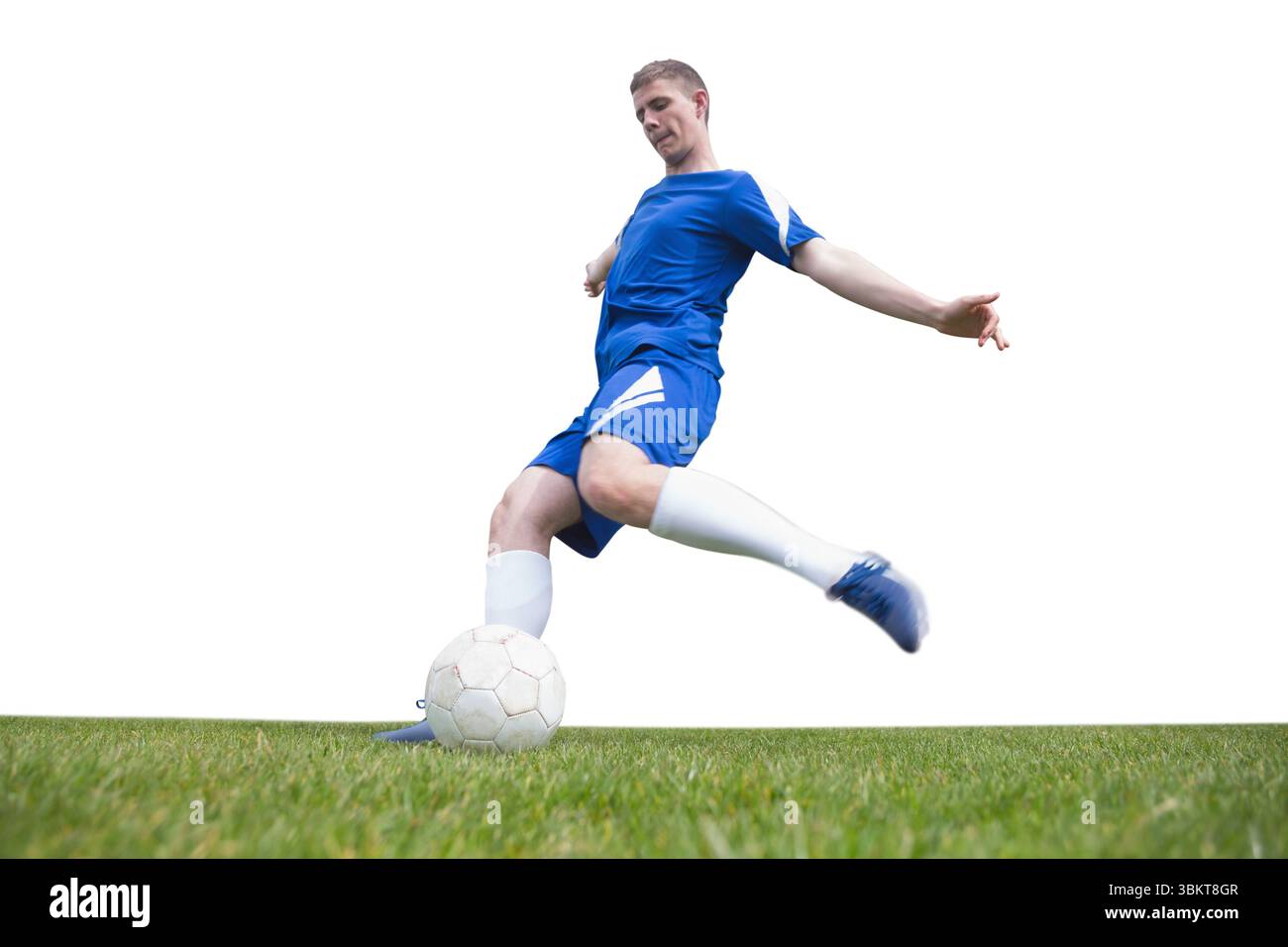 Football player kicking ball Stock Photo - Alamy