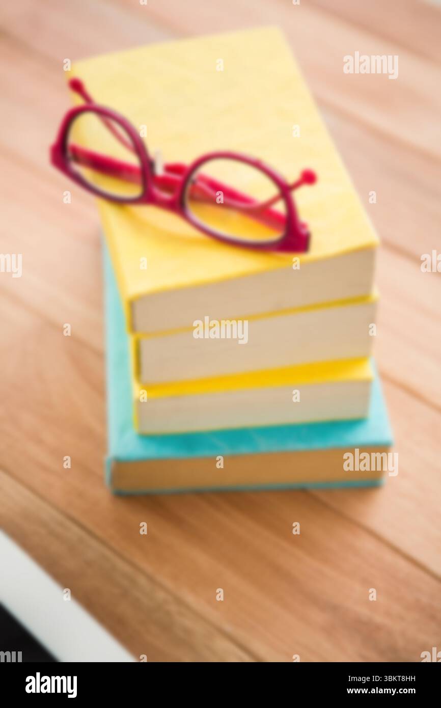Eyeglasses on stack of books Stock Photo - Alamy