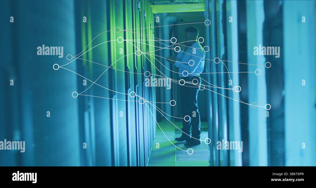 IT technician in white shirt inspecting server cabinets in server room ...