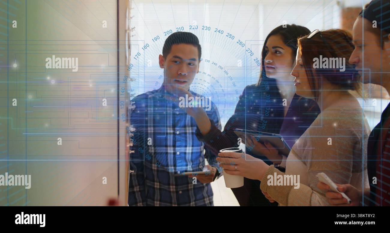 Collaborating team analyzing board diagrams, notes in office with ...