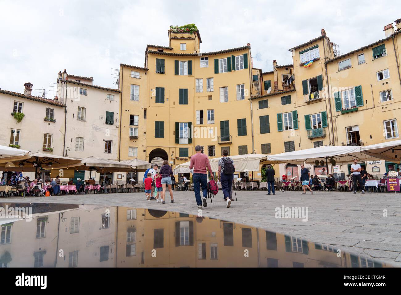 People walking and relaxing in Piazza dell'Anfiteatro, a famous square ...