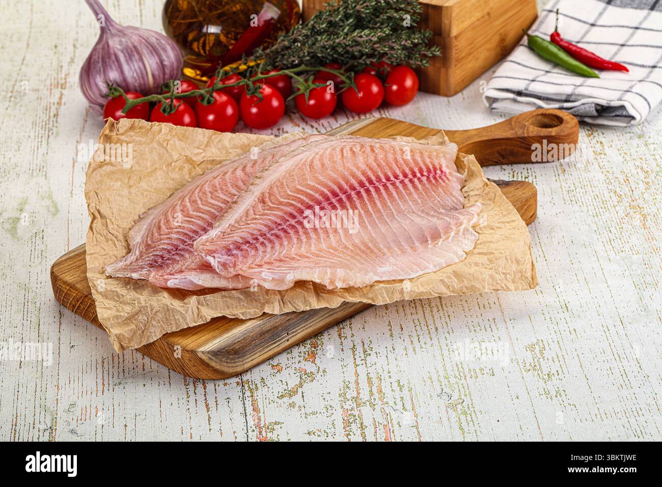 Raw Tilapia fish fillet slice uncooked Stock Photo - Alamy