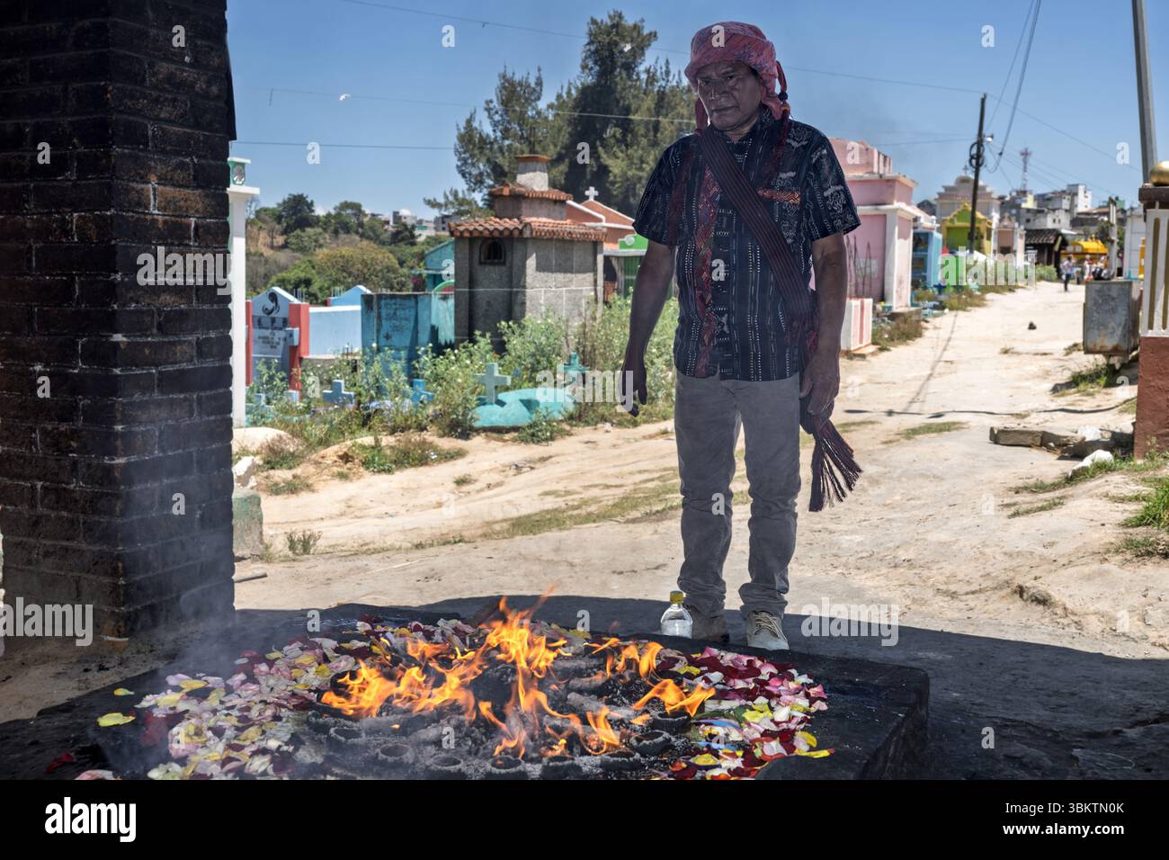 Mayan spiritual leader with ritual items inc candles, liquor, gigars ...