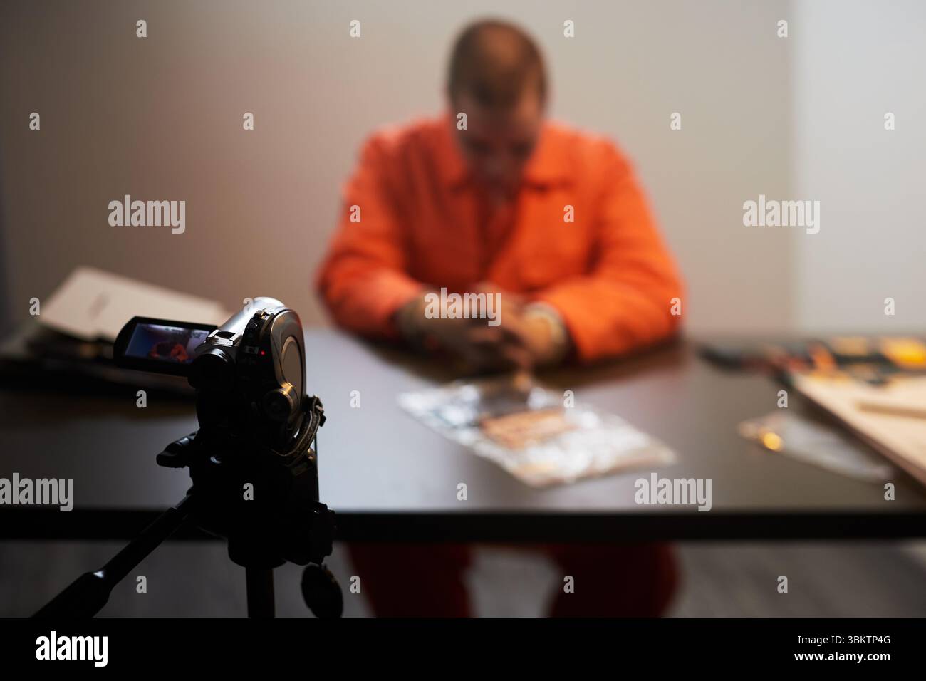 Caucasian middle aged woman wearing orange prison uniform sitting ...